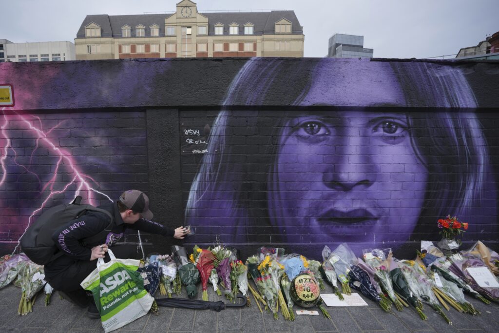 A fan lay flowers to commemorate the death of Ozzy Osbourne in Birmingham, Wednesday, July 23, 2025.