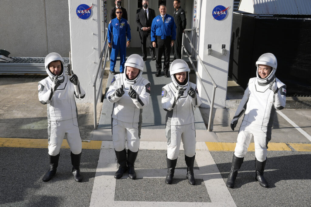 Astronauts, from left, Oleg Platonov, of Russia, Mike Fincke, Zena Cardman, and Kimiya Yui, of Japan, pose for a photo as they leave the Operations and Checkout Building for a trip the Kennedy Space Center's Launch Pad 39-A and a planned liftoff on a SpaceX Falcon 9 rocket Friday, Aug. 1, 2025, in Cape Canaveral , Fla.