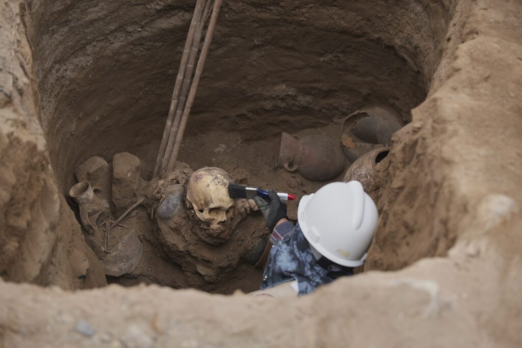 Archaeologist Jose Aliaga works at the site where city workers discovered ancient remains, from the pre-Inca Chancay culture, and artifacts as workers were digging a natural gas line for the company Calidda in the district of Puente Piedra on the outskirts of Lima, Peru, Thursday, July 31, 2025.