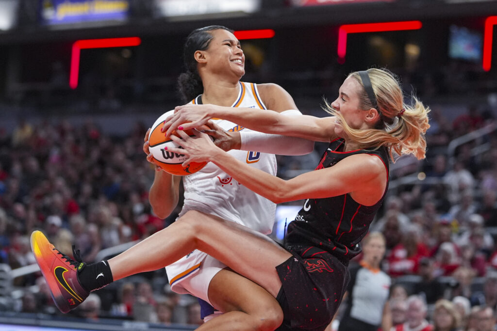 Indiana Fever guard Lexie Hull (10) blocks the shot over Phoenix Mercury forward Satou Sabally (0) in the first half of a WNBA basketball game in Indianapolis, Wednesday, July 30, 2025.